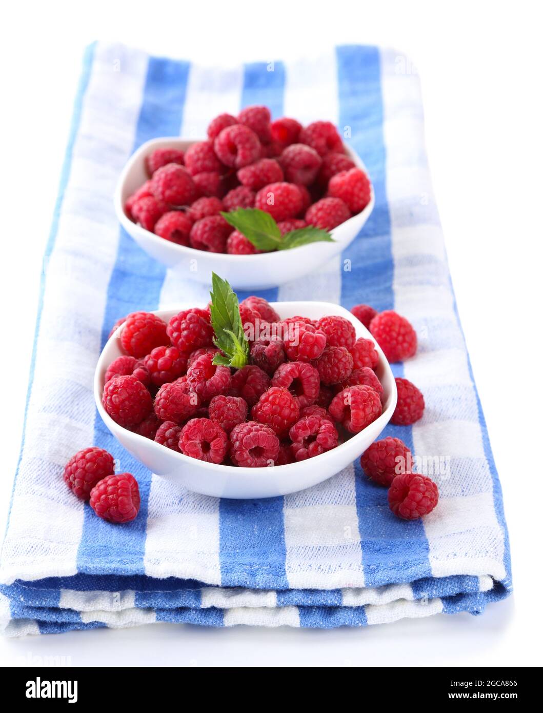 Ripe sweet raspberries in bowls, isolated on white Stock Photo - Alamy