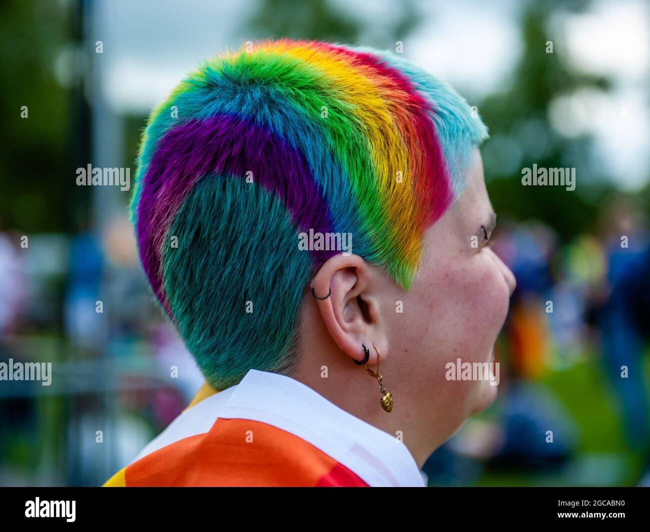 A protester with her hair dyed with the rainbow colors takes part ...