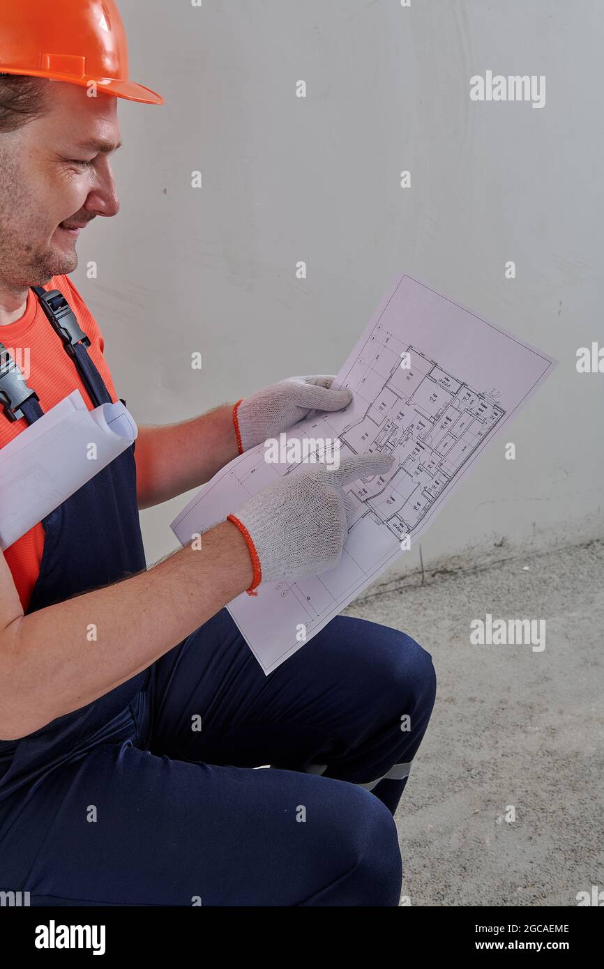 project drawing in the hands of an engineer Stock Photo - Alamy