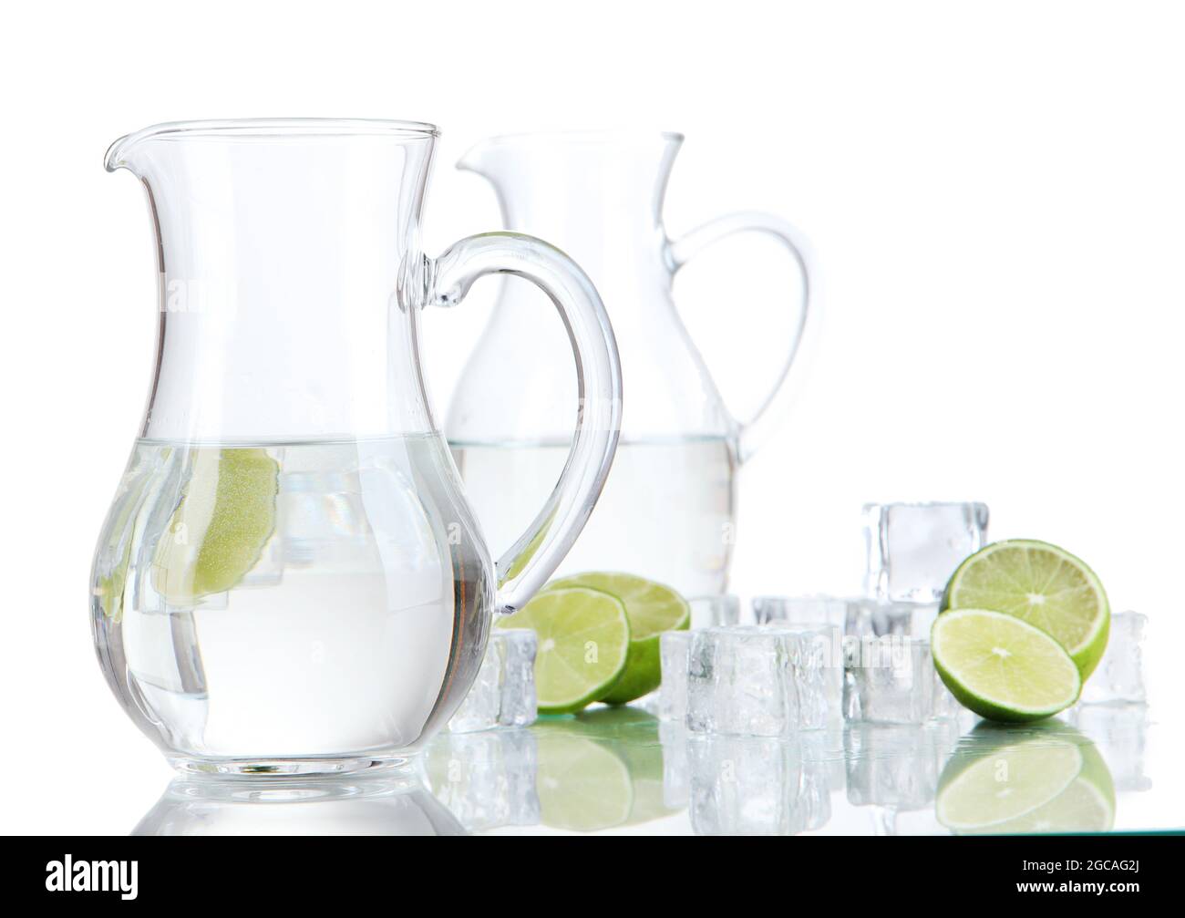Glass pitchers of water with ice and lime isolated on white Stock Photo ...
