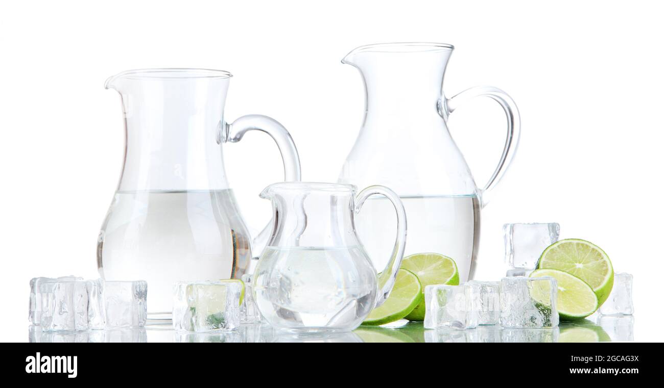 Glass pitchers of water with ice and lime isolated on white Stock Photo ...
