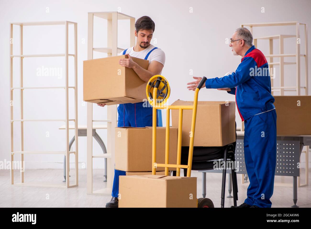 Two professional movers doing home relocation Stock Photo - Alamy