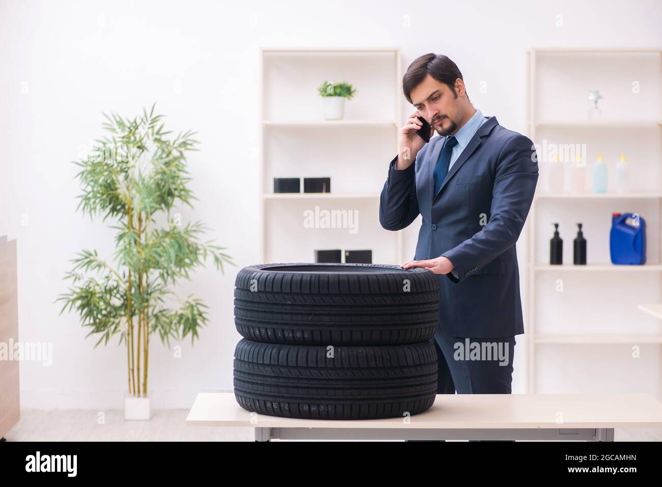 Young businessman selling tires in the office Stock Photo - Alamy