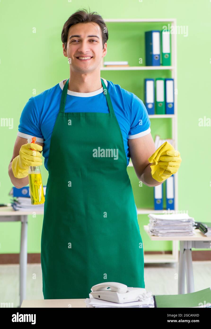 The male handsome professional cleaner working in the office Stock ...