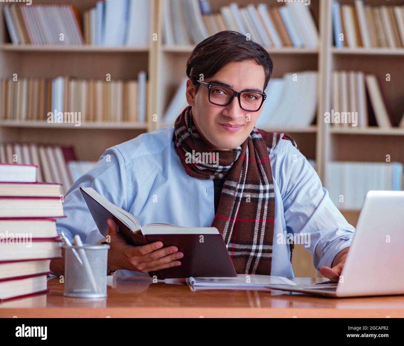 The young book writer writing in library Stock Photo - Alamy