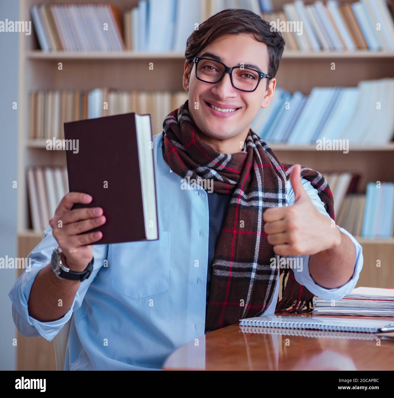 The young book writer writing in library Stock Photo - Alamy