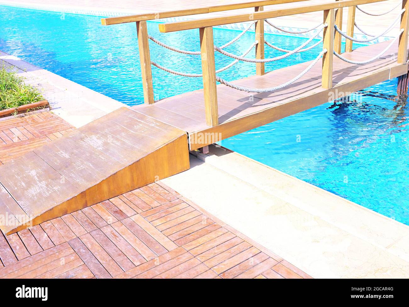 Bridge across hotel swimming pool Stock Photo - Alamy