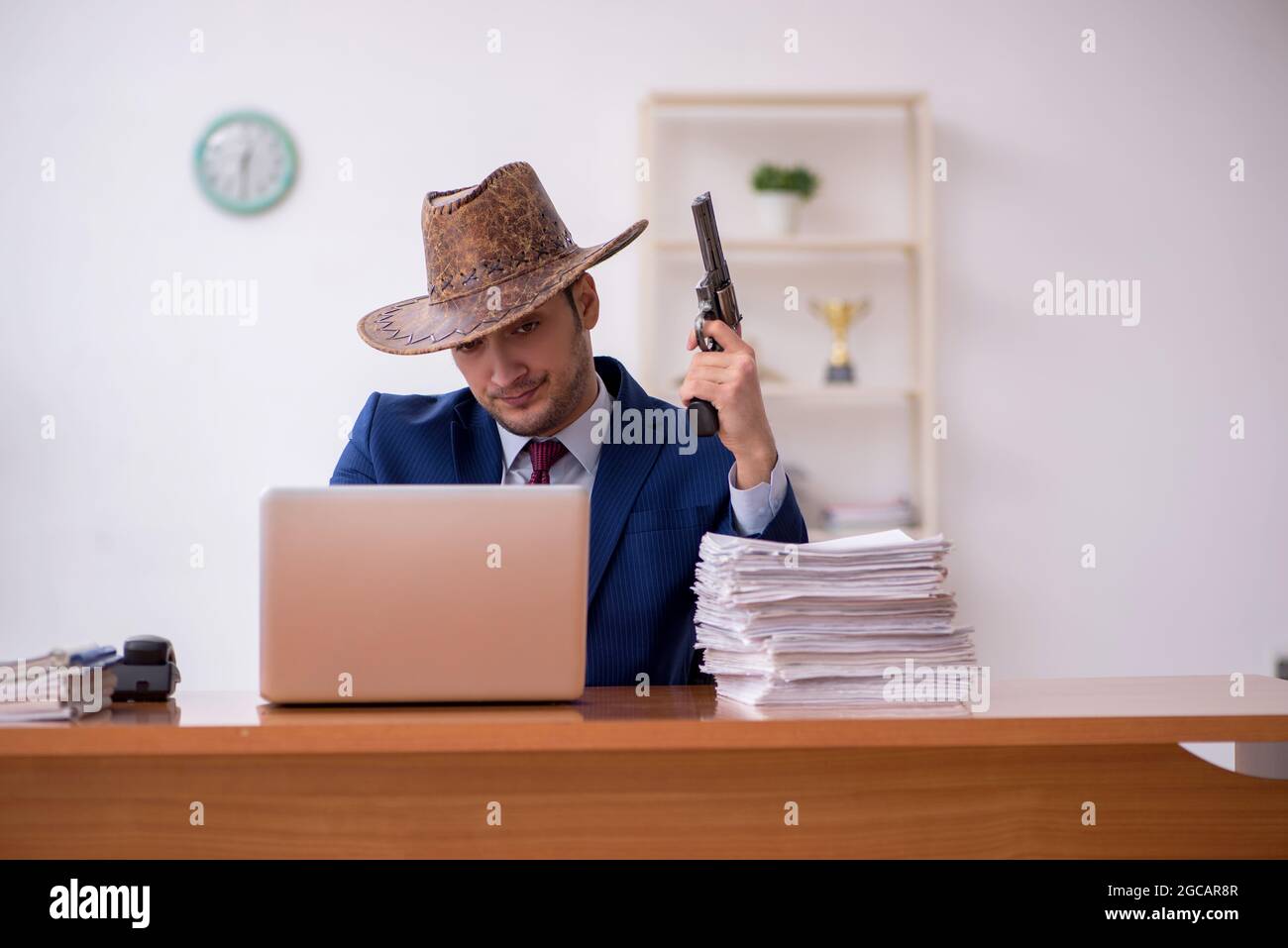 Young cowboy employee working at workplace Stock Photo - Alamy