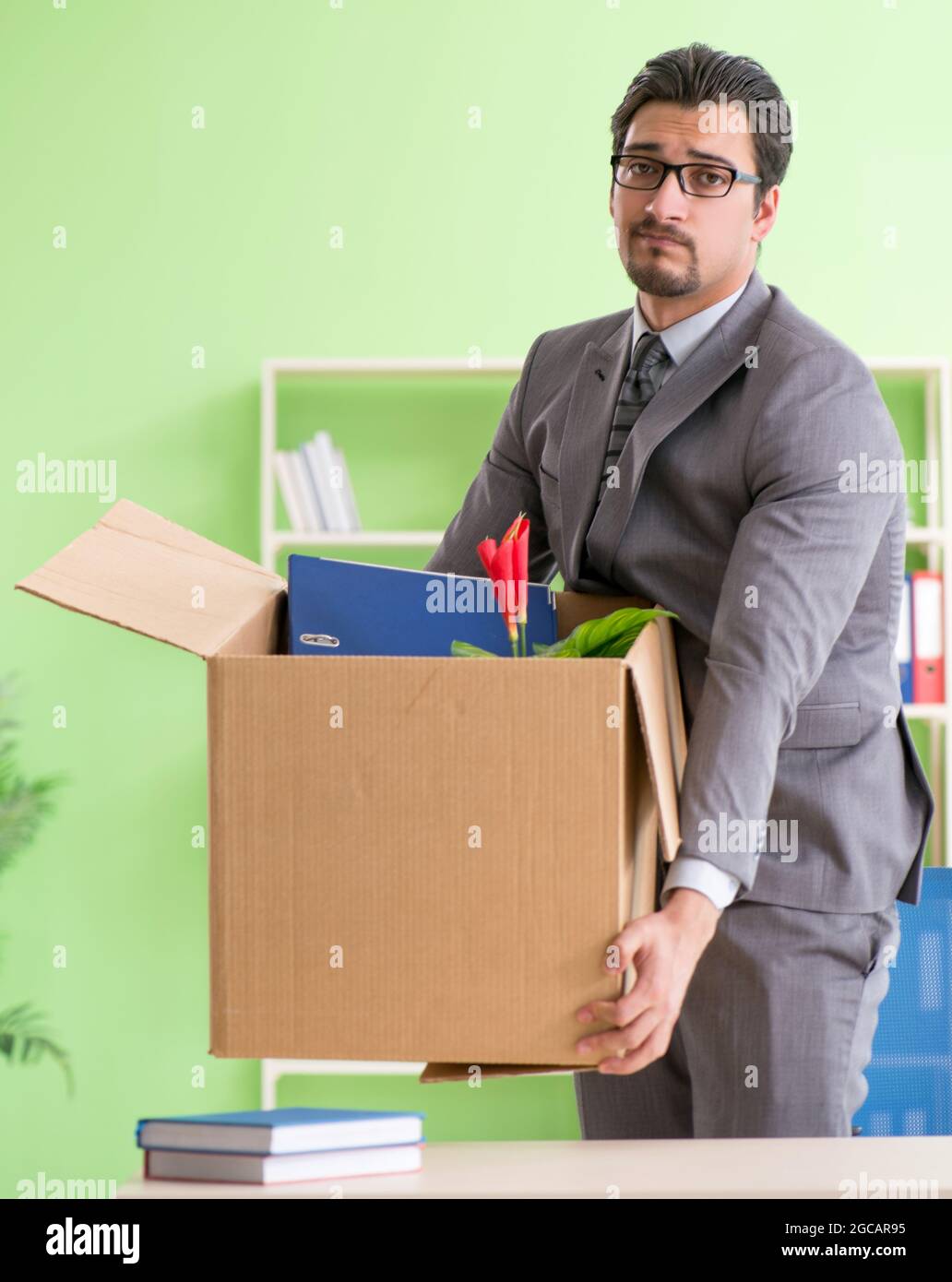 The male employee collecting his stuff after redundancy Stock Photo - Alamy