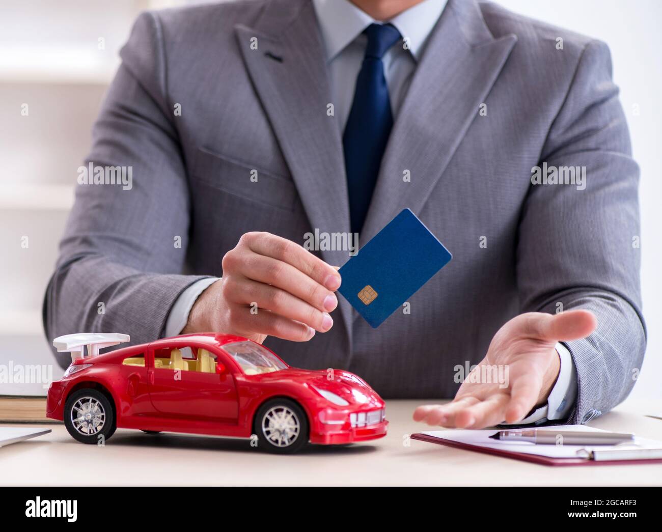 The agent offering car motor insurance Stock Photo - Alamy