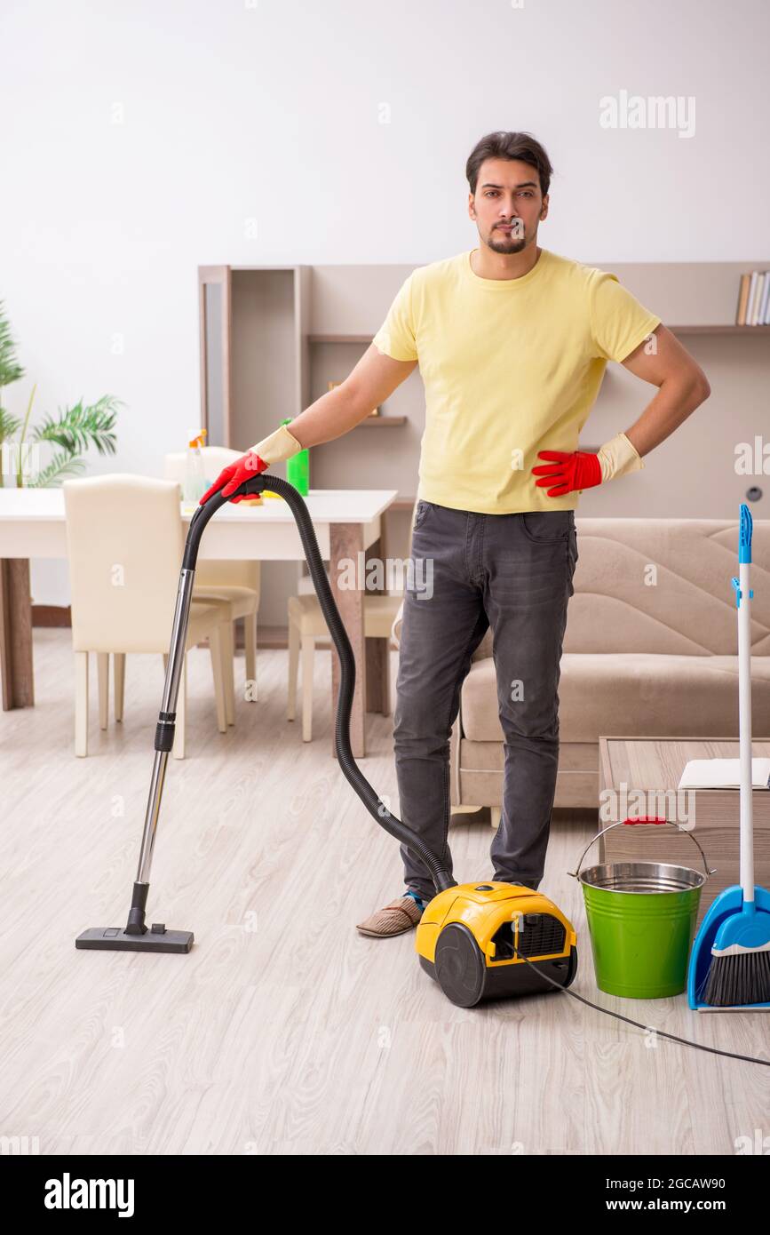 Young male cleaner cleaning the house Stock Photo - Alamy