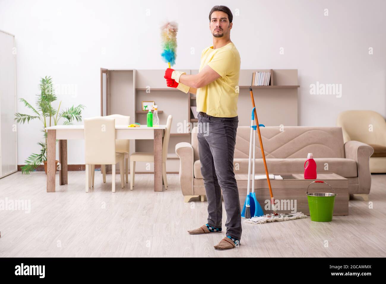 Young male cleaner cleaning the house Stock Photo - Alamy