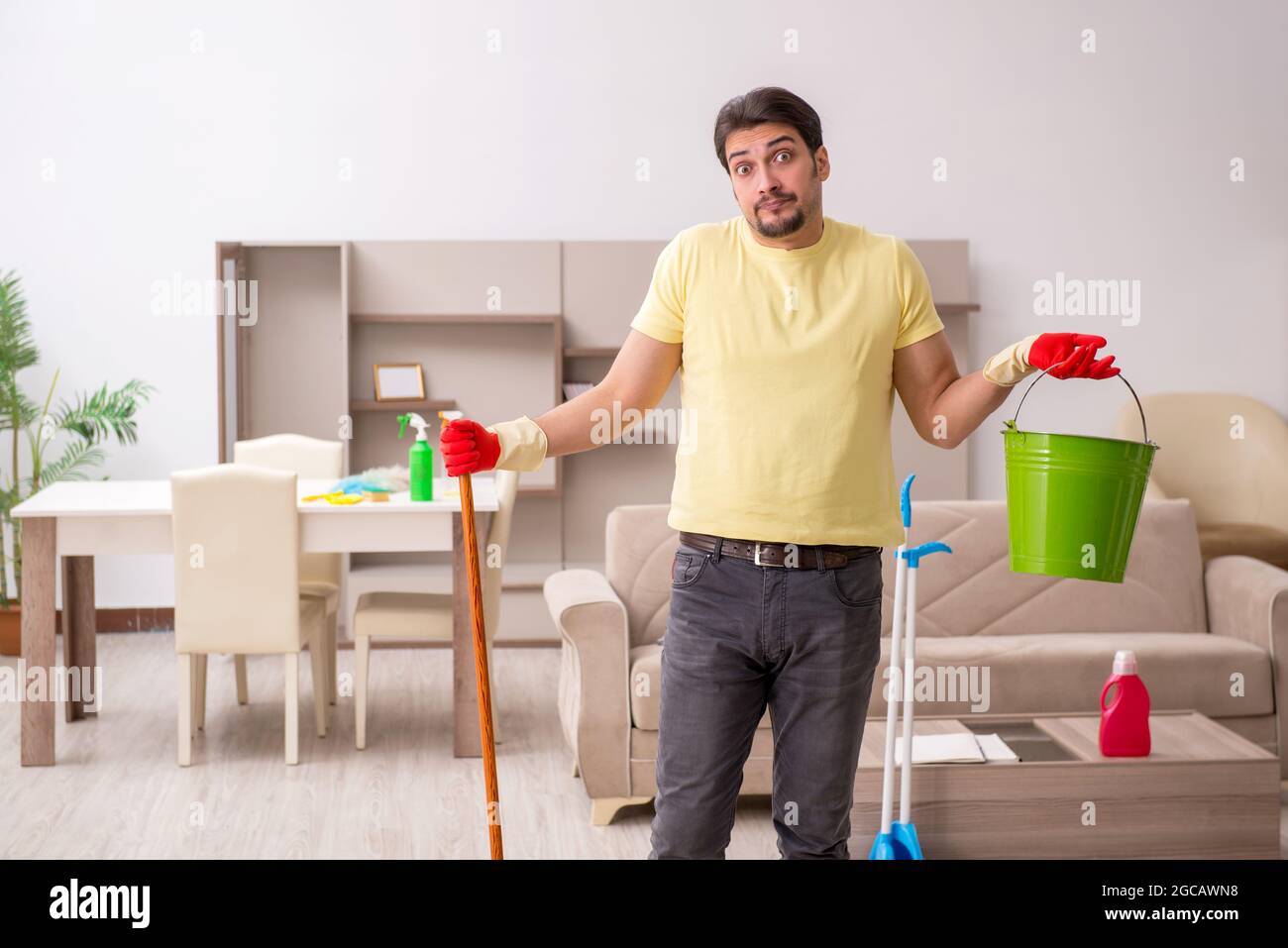 Young male cleaner cleaning the house Stock Photo - Alamy