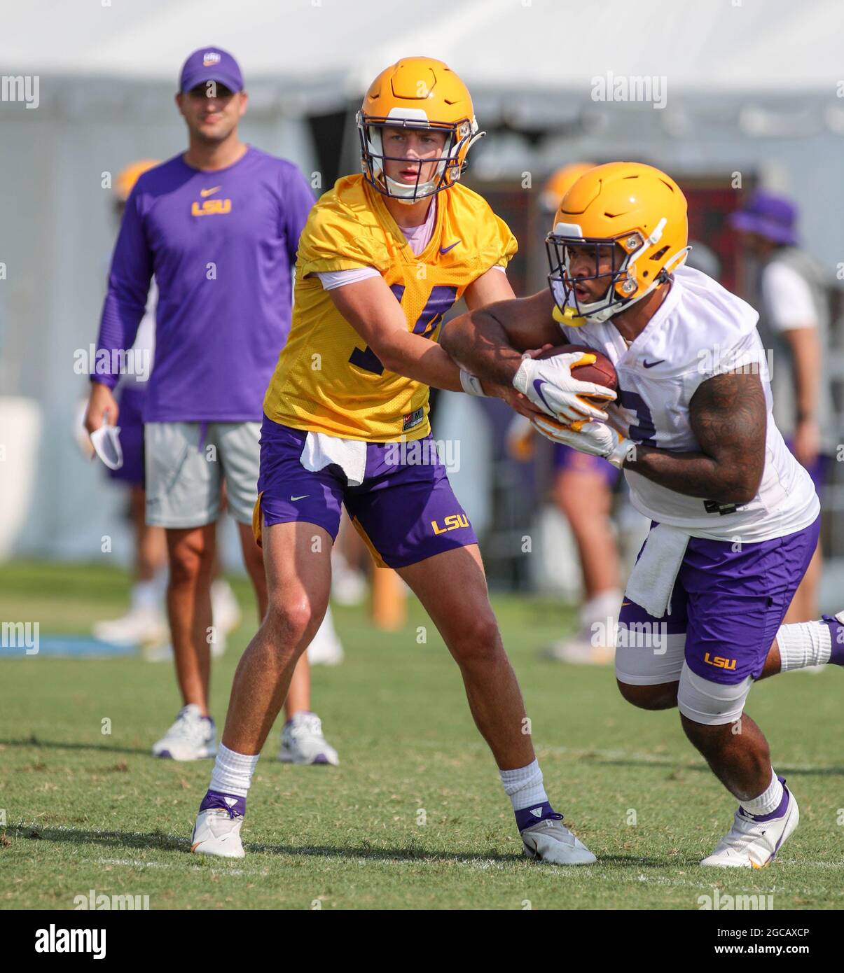 August 7, 2021: LSU quarterback Max Johnson (14) works a hand off drill ...