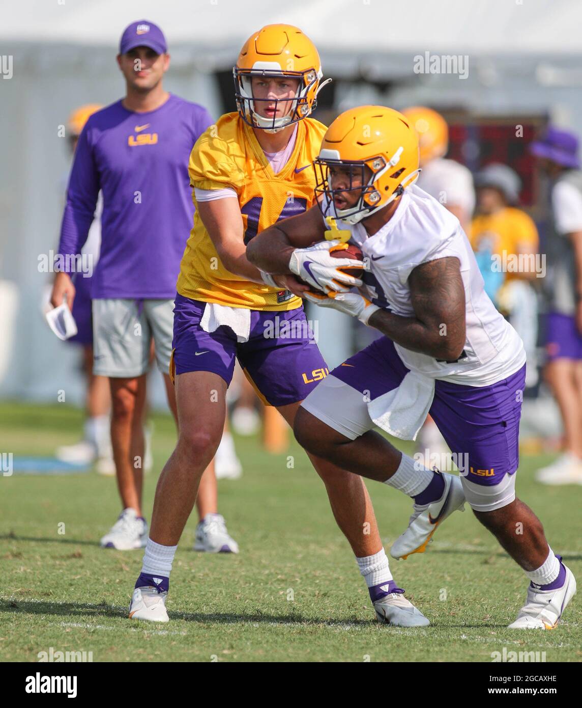 August 7, 2021: LSU quarterback Max Johnson (14) works a hand off drill ...