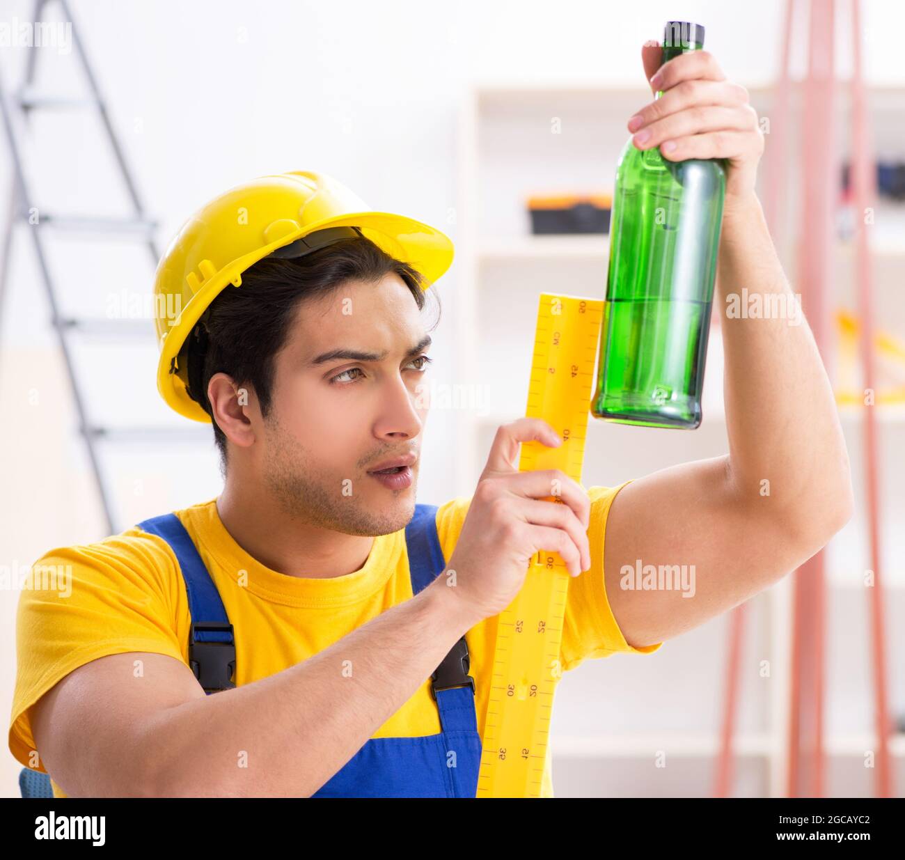 The drunk engineer working in the workshop Stock Photo - Alamy
