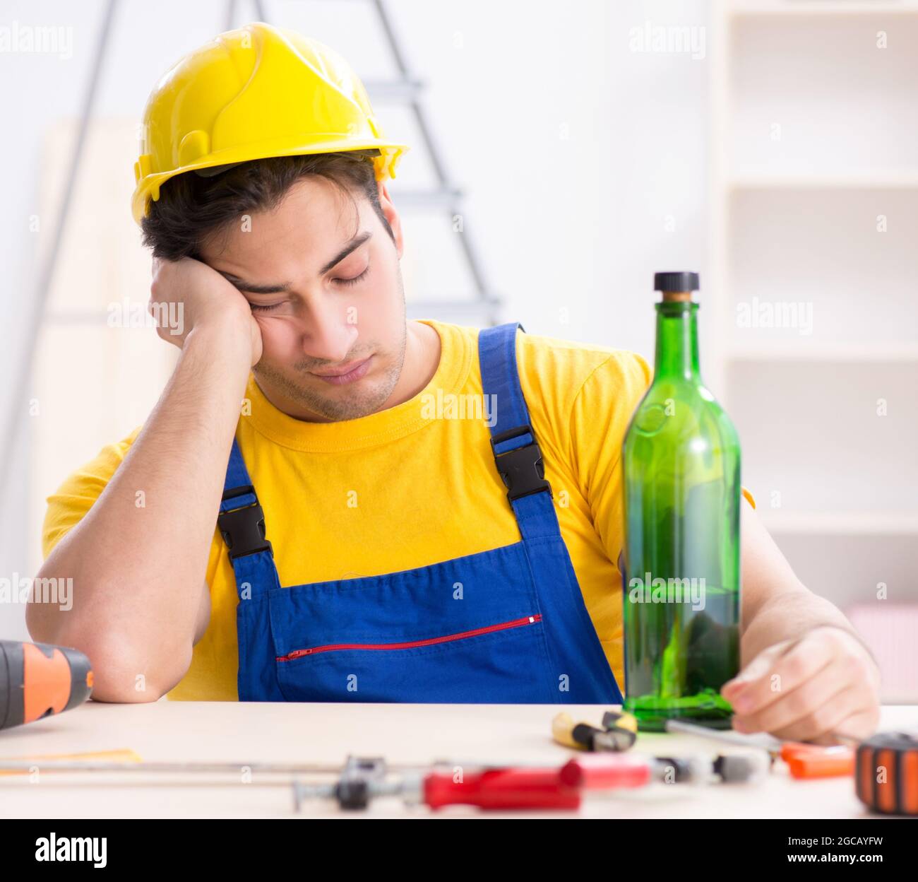 The drunk engineer working in the workshop Stock Photo - Alamy