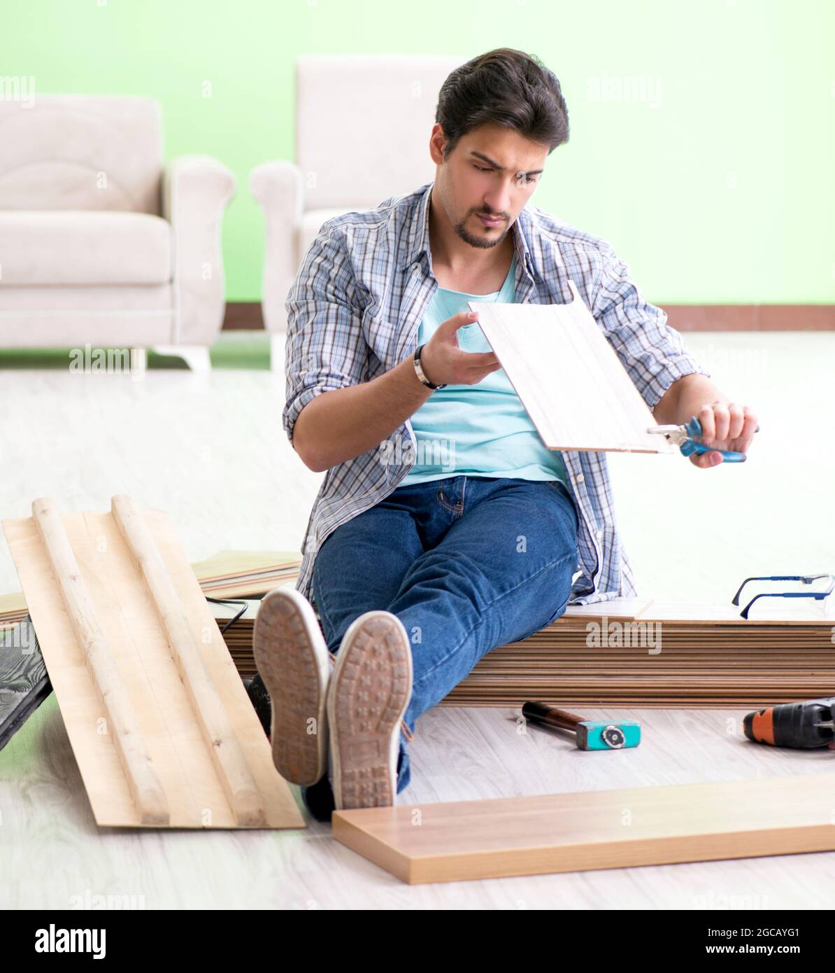 The man laying flooring at home Stock Photo - Alamy