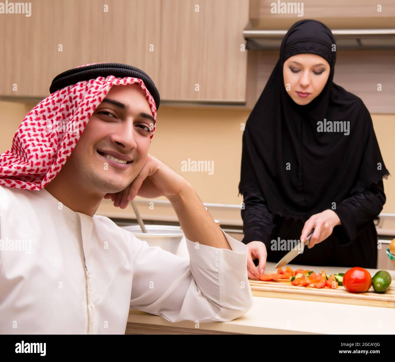 The young arab family in the kitchen Stock Photo - Alamy