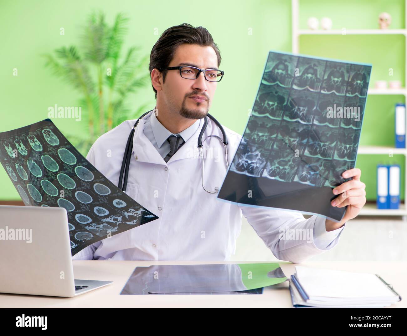 The doctor radiologist looking at x-ray scan in hospital Stock Photo ...
