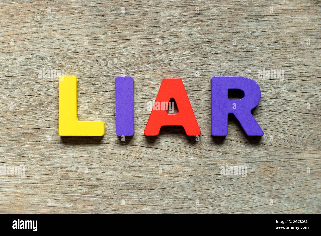 Color alphabet letter in word liar on wood background Stock Photo - Alamy