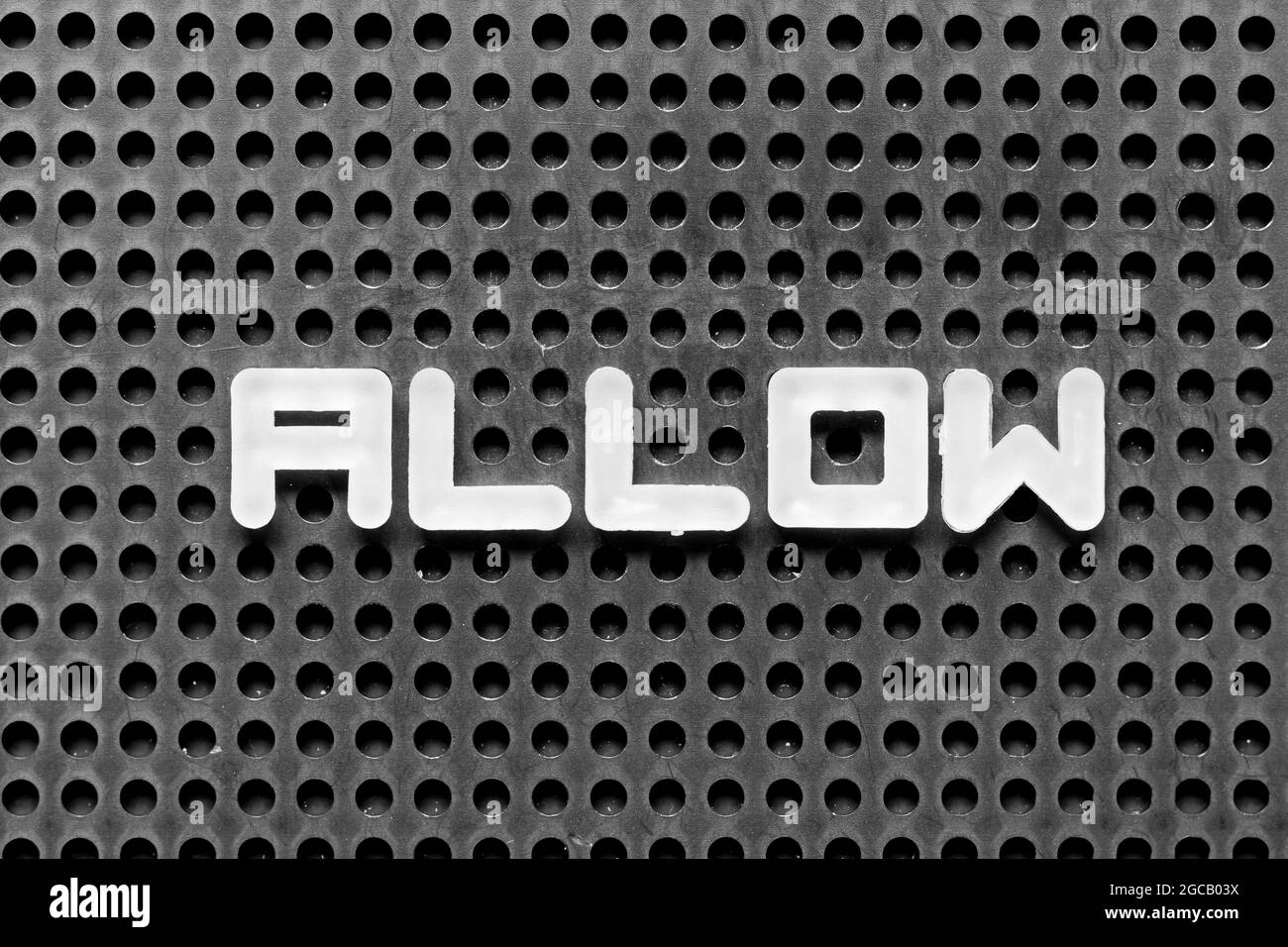 White alphabet letter in word allow on black pegboard background Stock ...