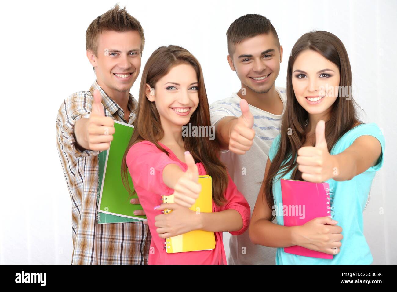 Group of happy beautiful young students at room Stock Photo - Alamy