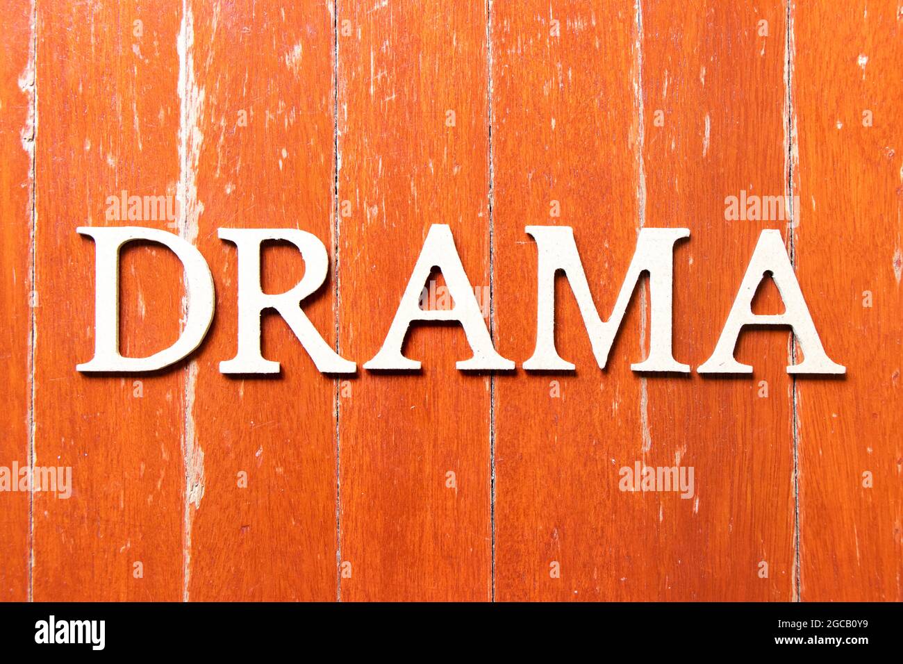 Alphabet letter in word drama on old red color wood plate background ...