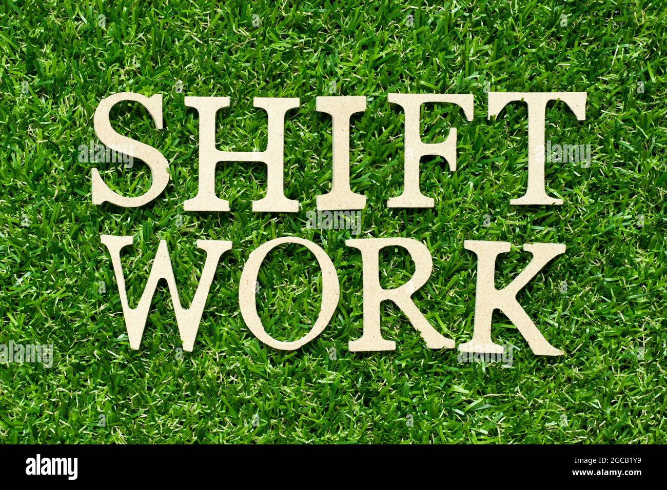 Wood letter in word shift work on green grass background Stock Photo ...