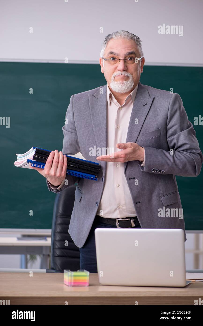 Old teacher in front of blackboard Stock Photo - Alamy