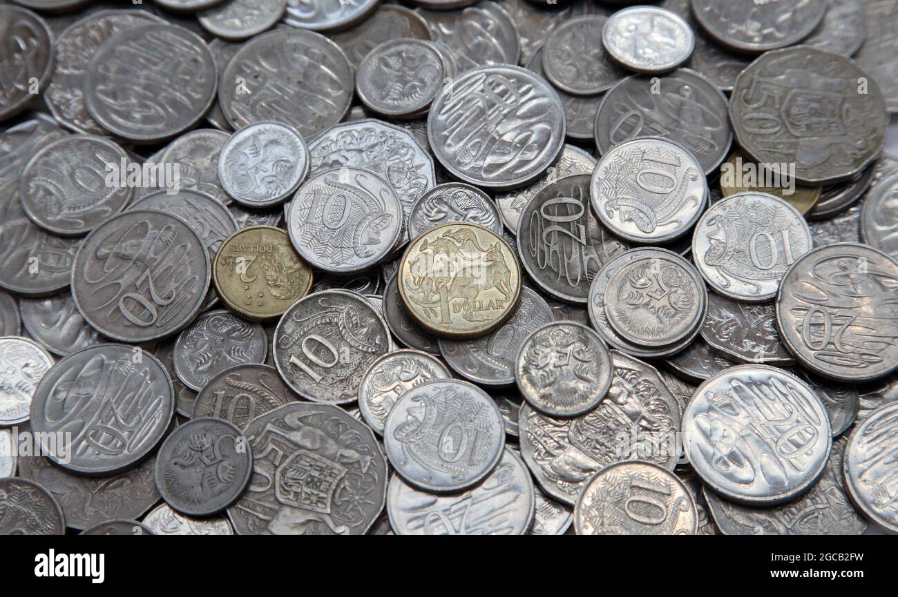 Various Australia coins in a pile. Focus on central gold coloured one ...
