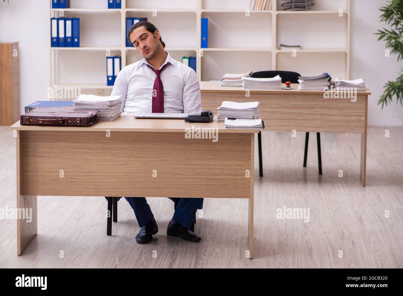 Extremely tired businessman male employee in the office Stock Photo - Alamy