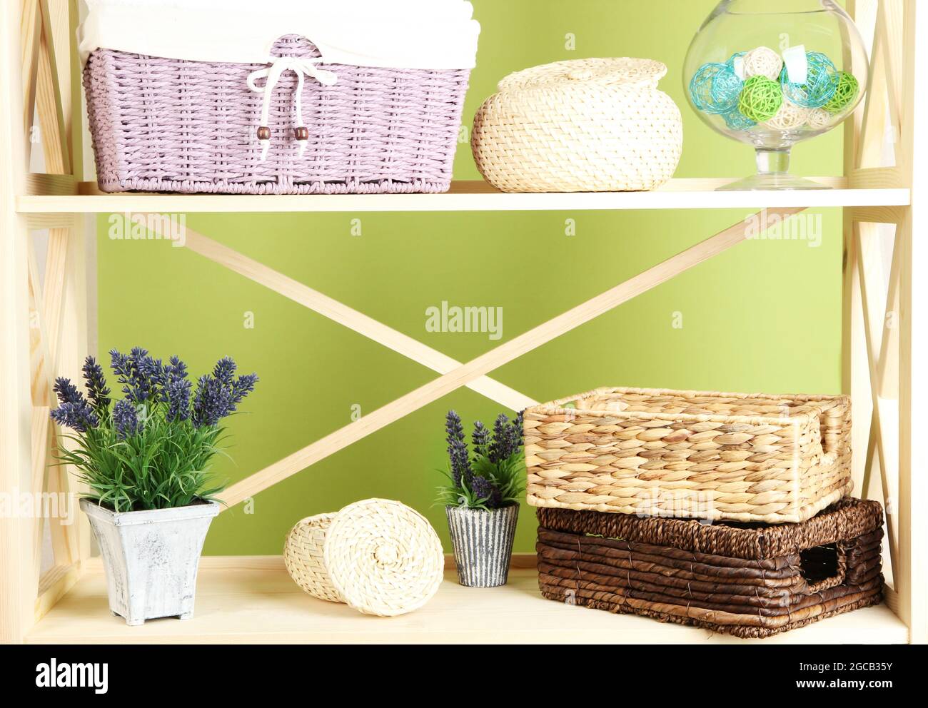 Beautiful white shelves with different home related objects, on color ...