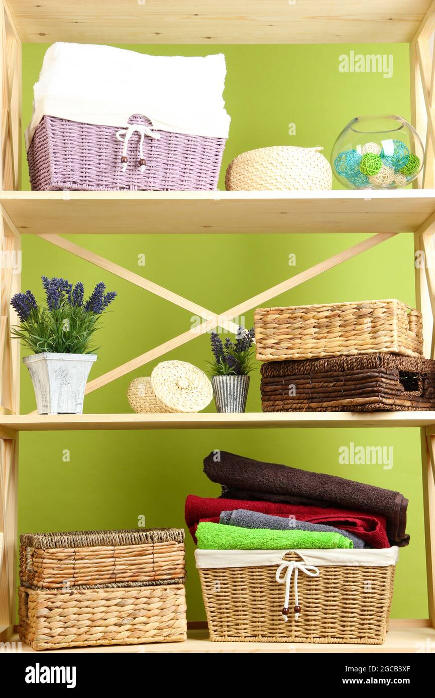 Beautiful white shelves with different home related objects, on color ...