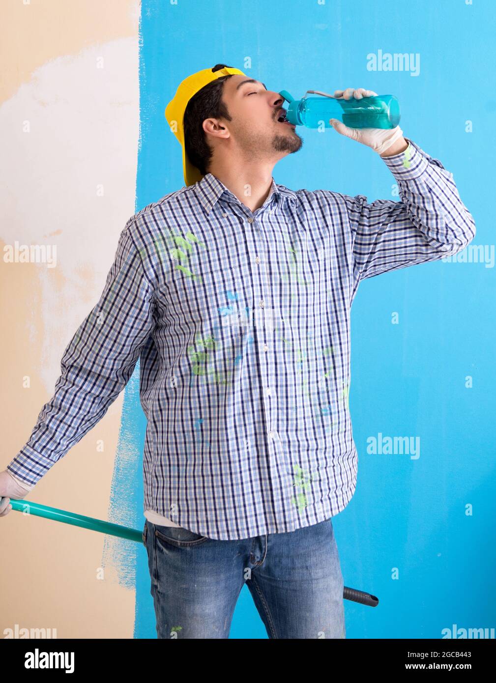 The painter man painting the wall at home Stock Photo - Alamy