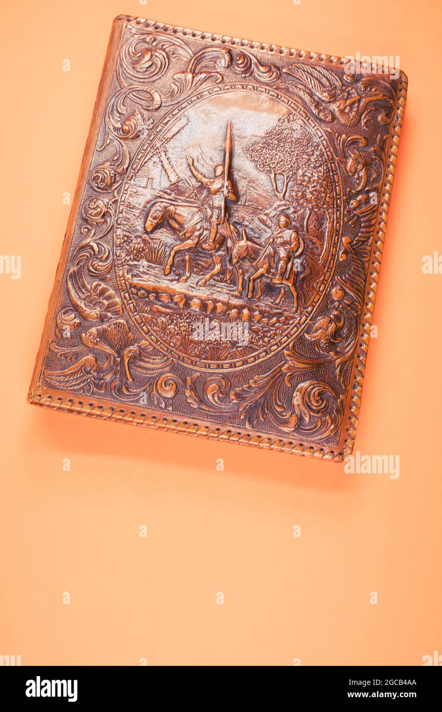 A brown leather wallet isolated on an orange background with free space ...