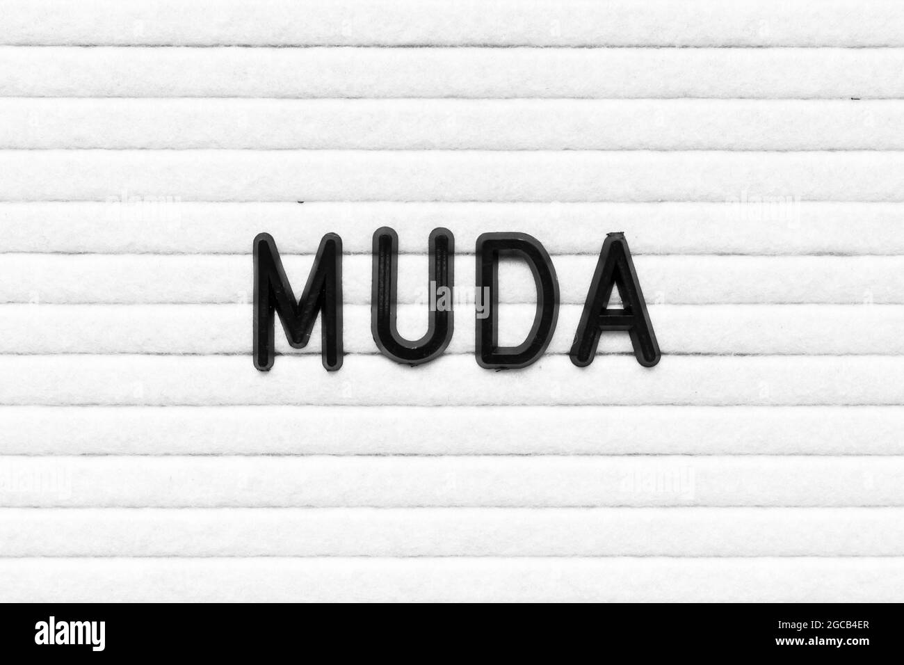 Black alphabet letter in word muda on white felt board background Stock ...