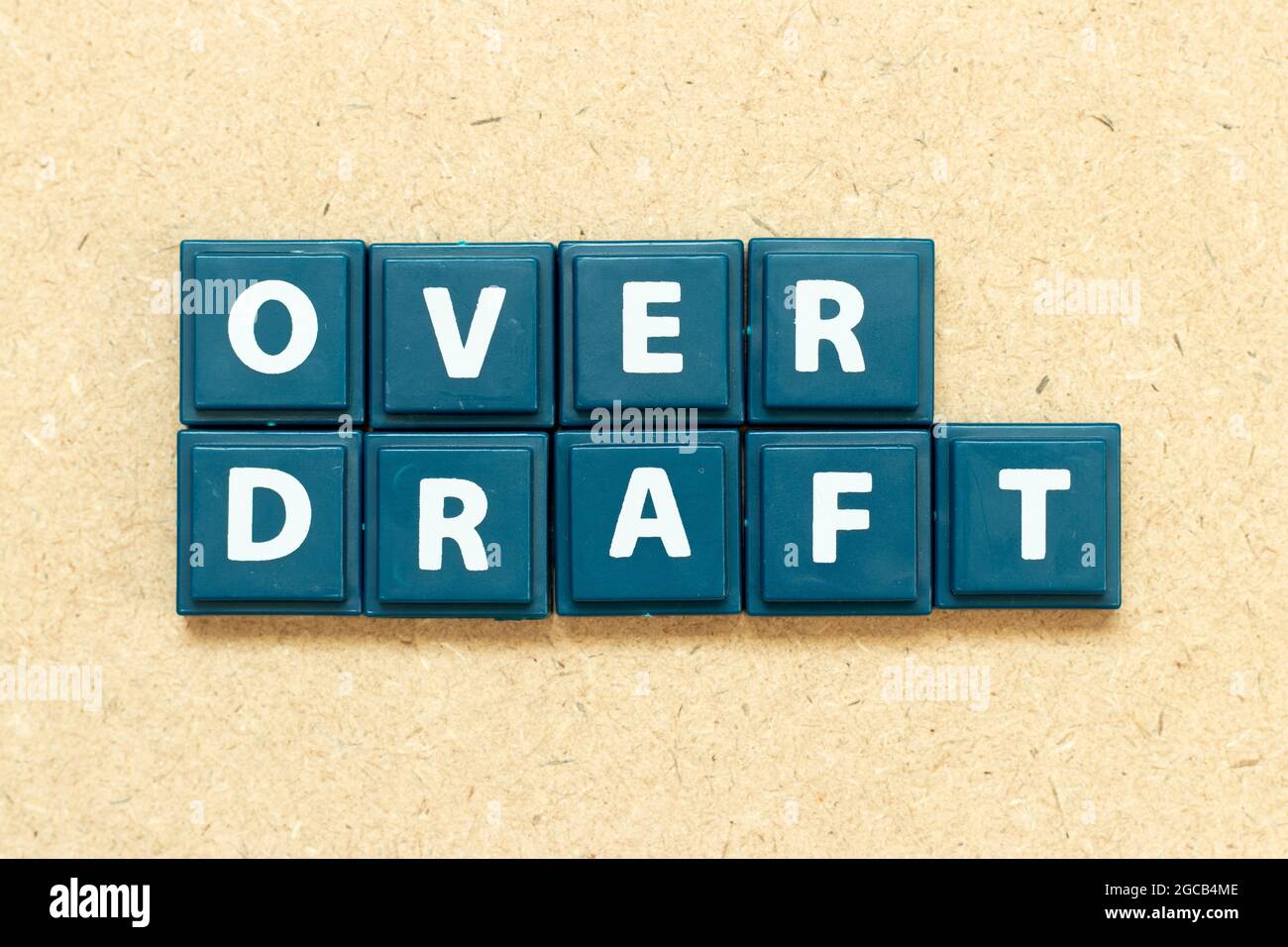 Tile alphabet letter in word overdraft on wood background Stock Photo ...