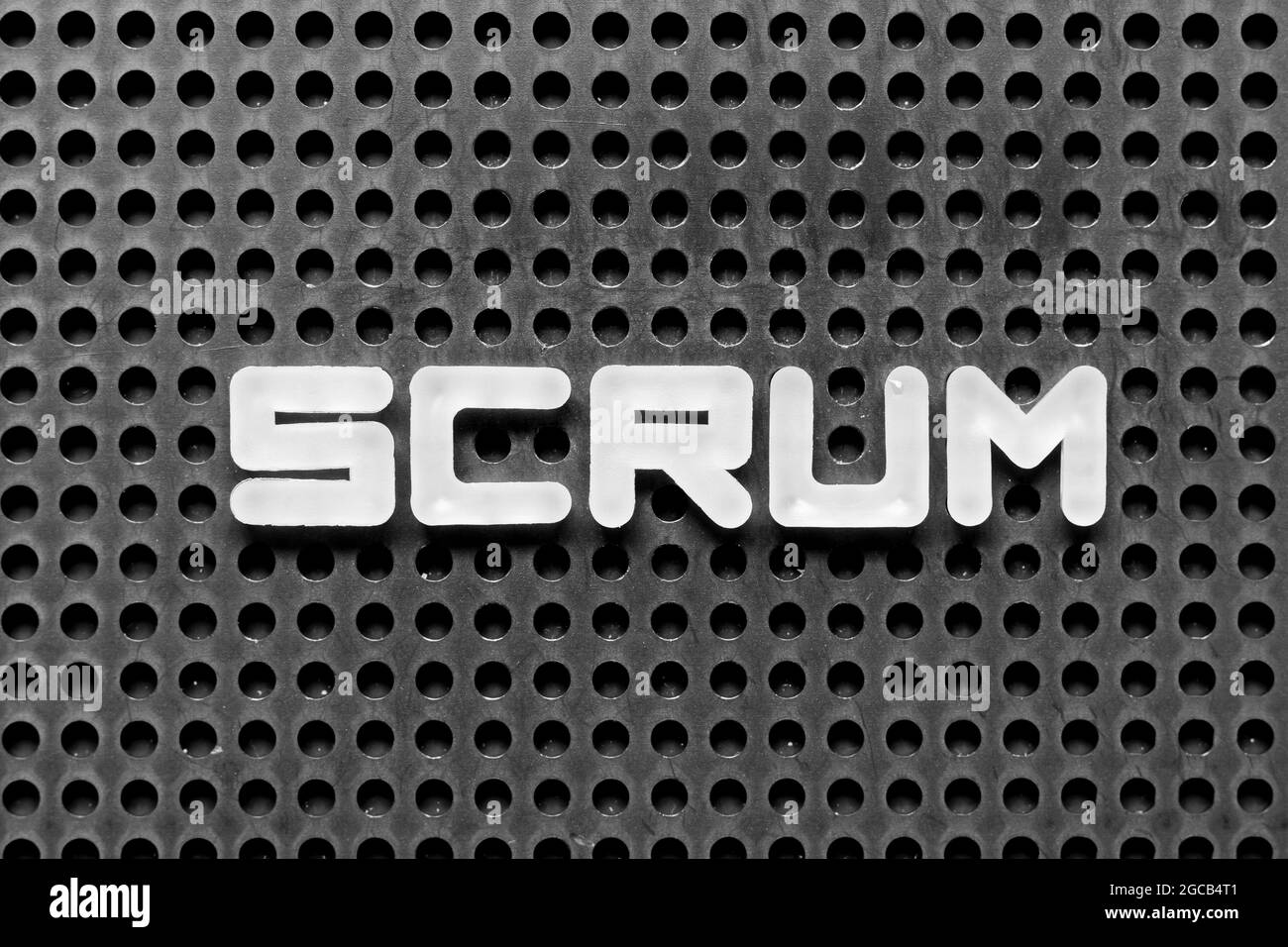 White alphabet letter in word scrum on black pegboard background Stock ...
