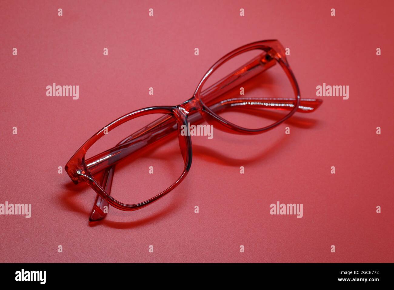 Image of modern fashionable spectacles isolated on red background ...