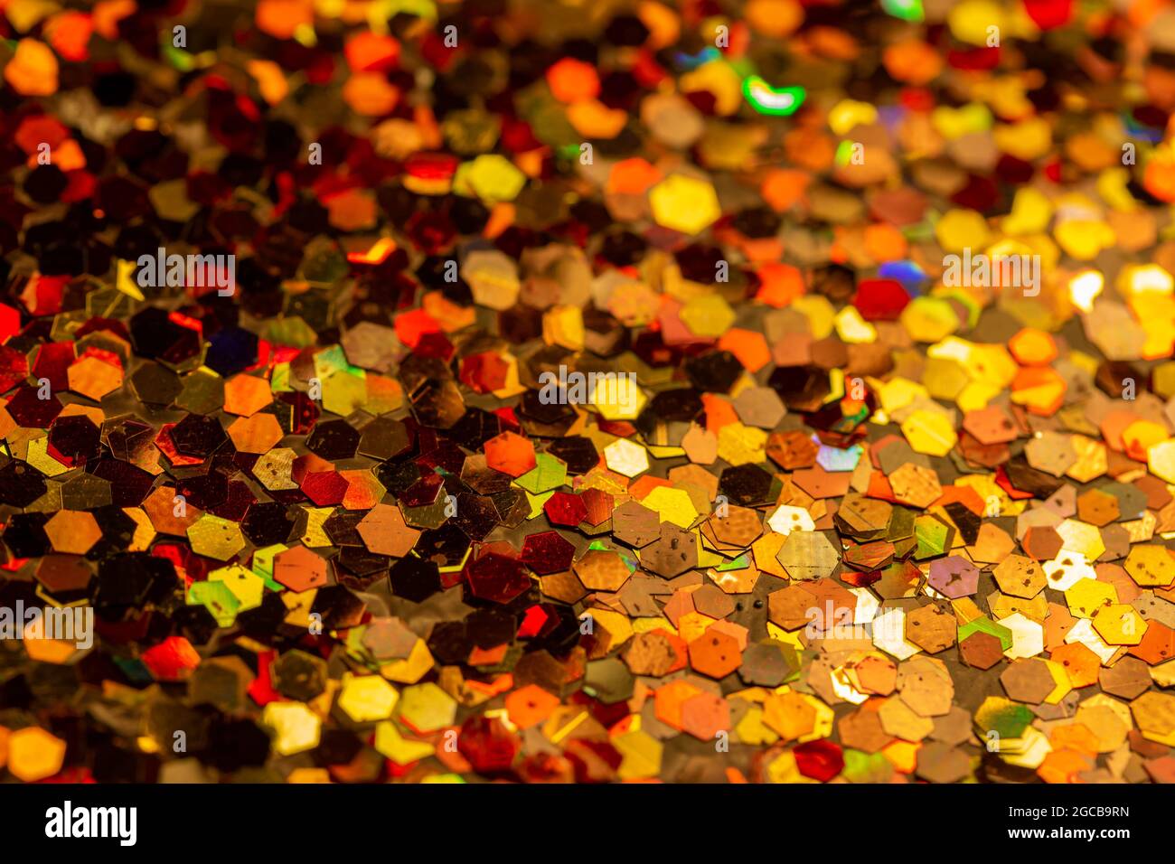 Sparkling red glitter macro texture background with vibrant autumn ...