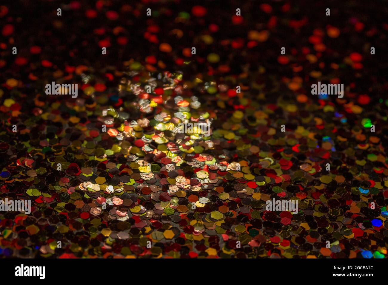 Sparkling red glitter macro texture background with vibrant autumn ...