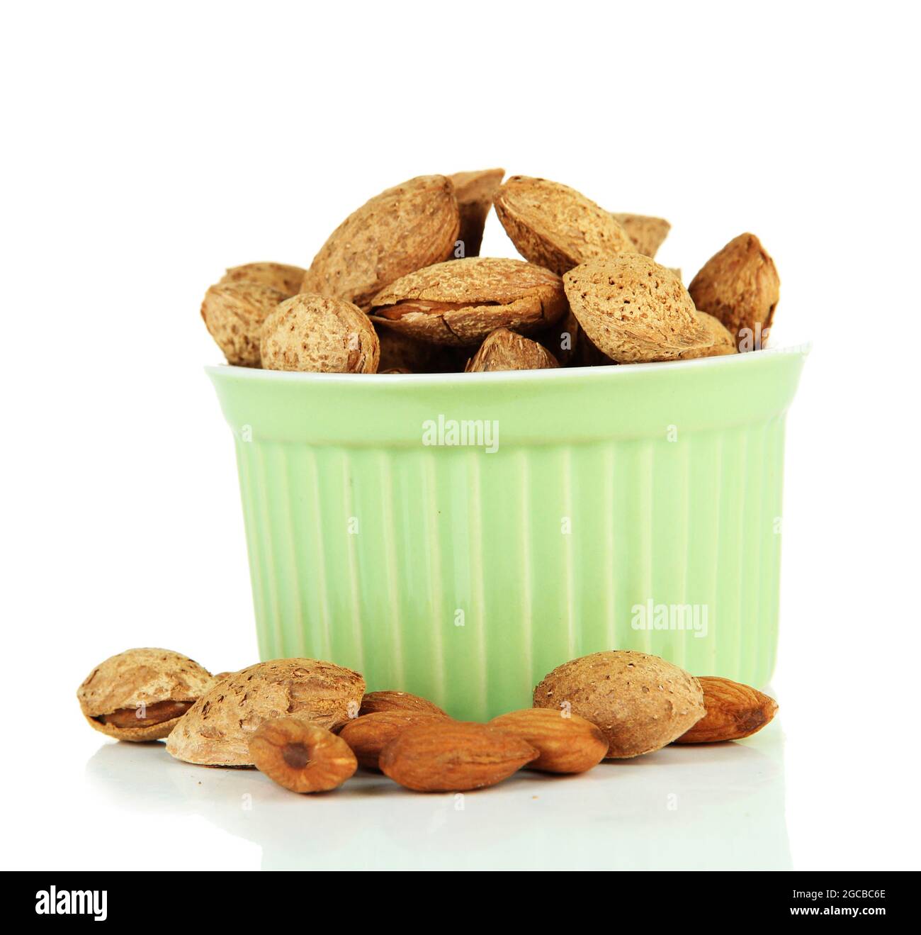 Almond in bowl, isolated on white Stock Photo - Alamy