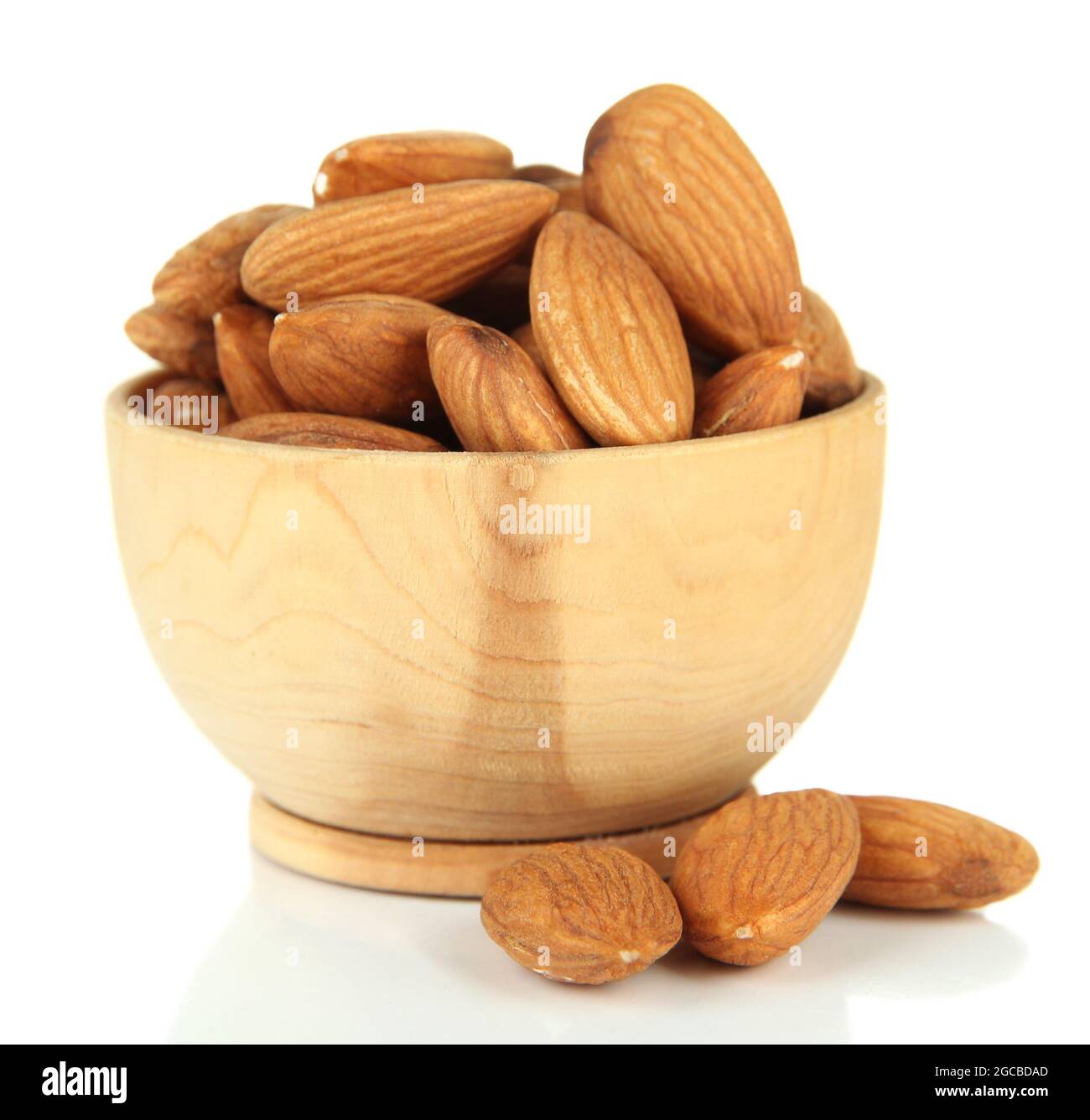 Almond in wooden bowl, isolated on white Stock Photo - Alamy