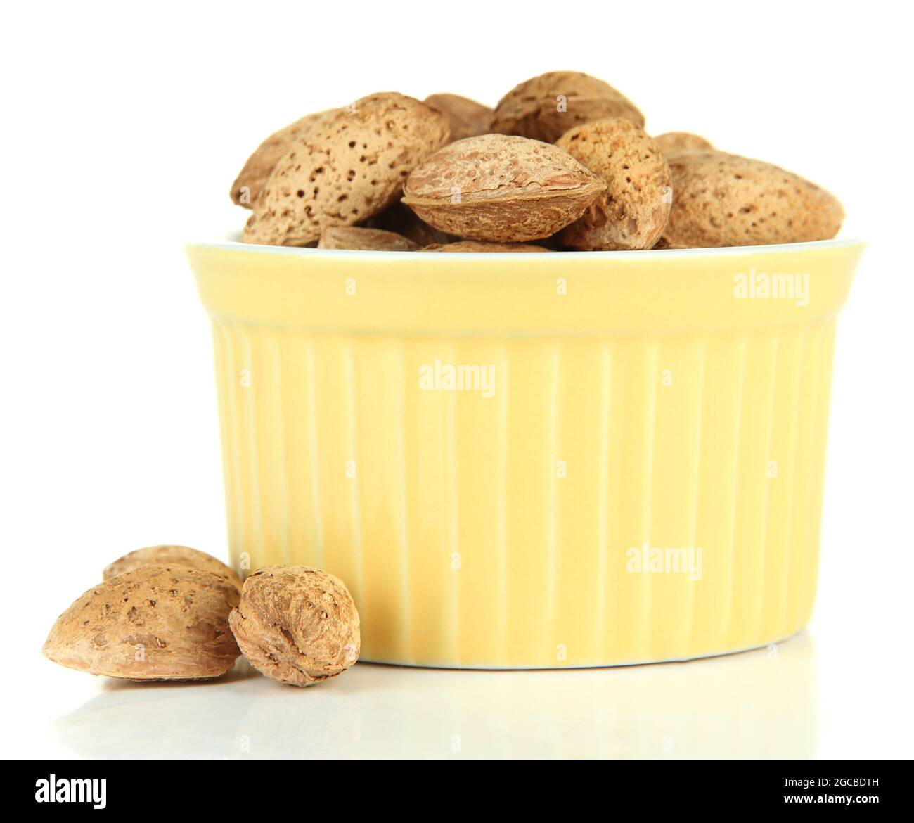 Almond in bowl, isolated on white Stock Photo - Alamy