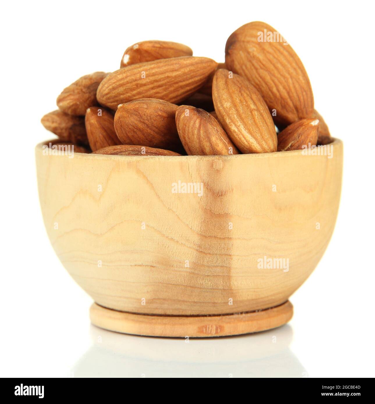 Almond in wooden bowl, isolated on white Stock Photo - Alamy
