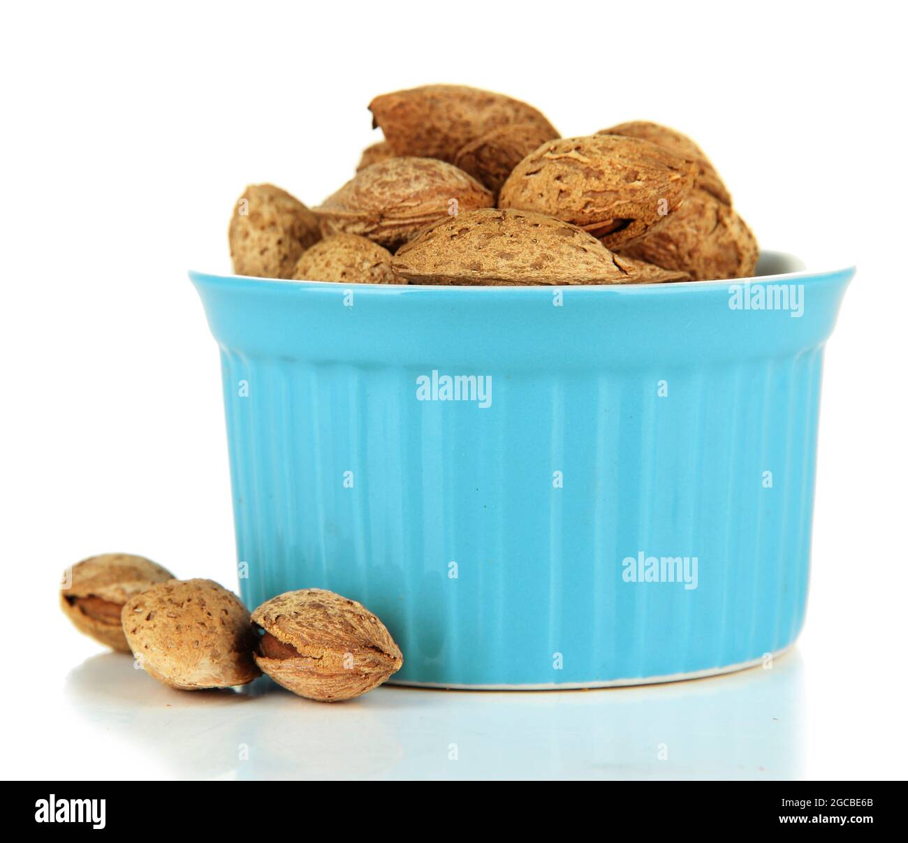 Almond in bowl, isolated on white Stock Photo - Alamy