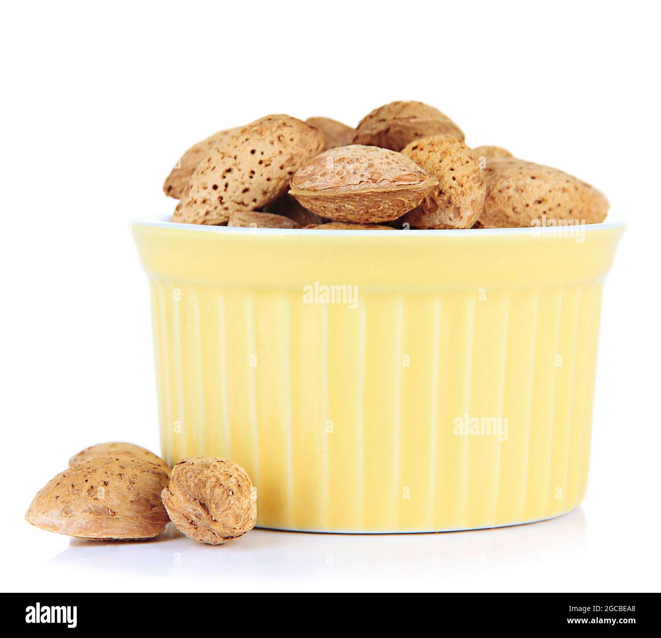Almond in bowl, isolated on white Stock Photo - Alamy