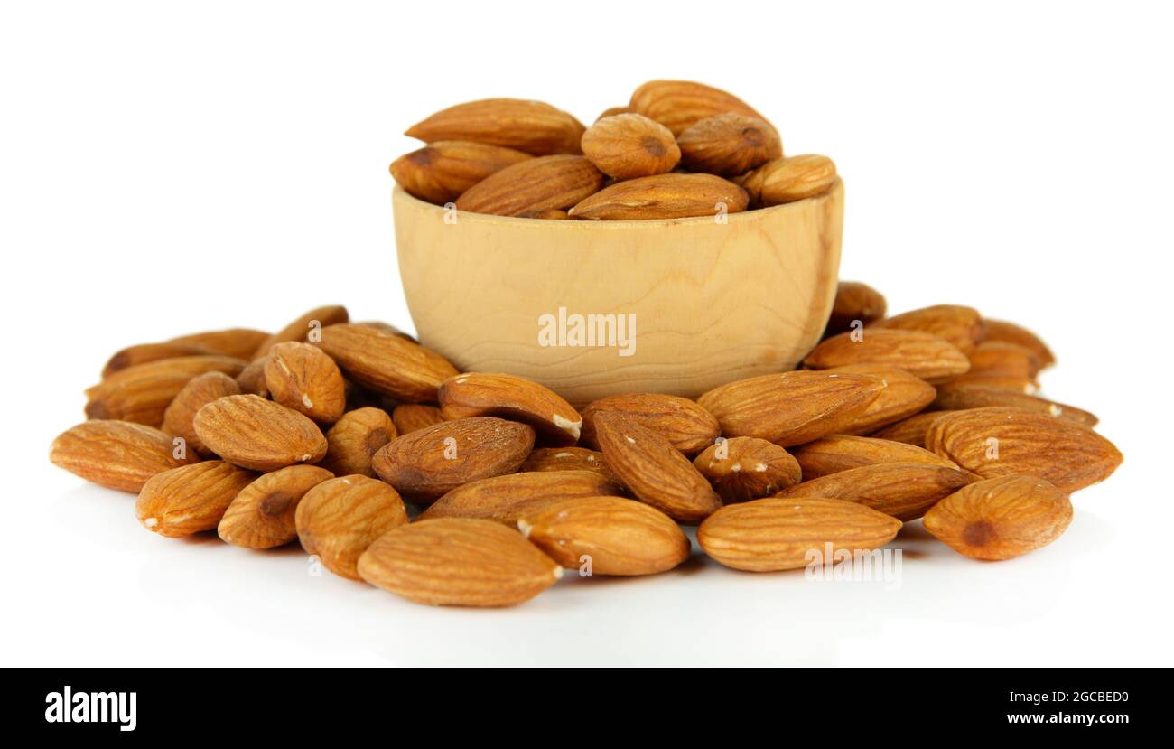 Almond in wooden bowl, isolated on white Stock Photo - Alamy