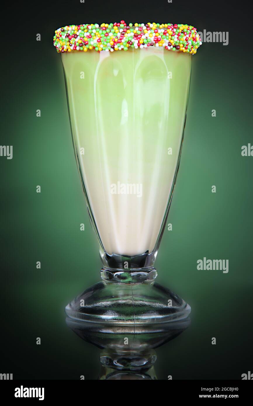 Delicious milk shake on dark green background Stock Photo - Alamy